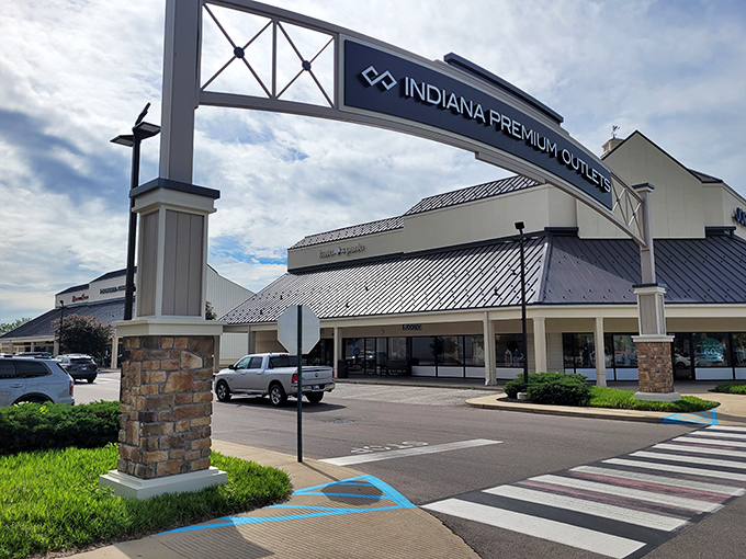 The grand entrance to Indiana Premium Outlets showcases its impressive brand lineup &ndash; where your wallet trembles with both fear and excitement.