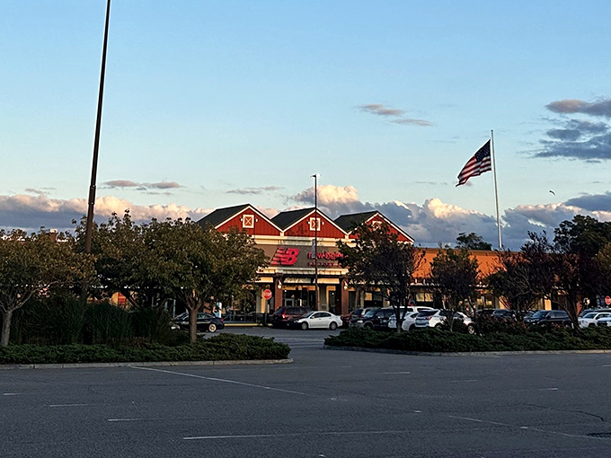 Tanger Outlets at twilight – where shopping dreams come true and credit cards get their daily exercise. The peaceful evening ambiance belies the retail frenzy within.