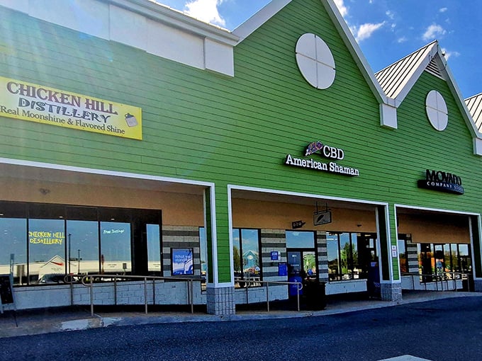 The distinctive green facade of Chicken Hill Distillery welcomes bargain hunters with a splash of color among the outlet's practical architecture.