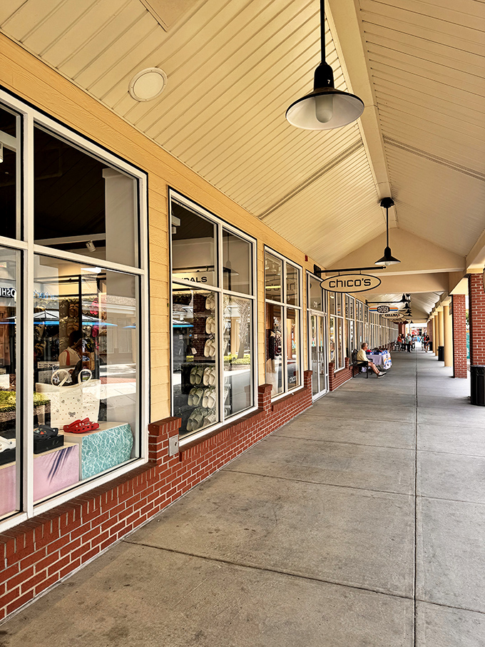 The grand entrance to Tanger Outlets stands like a retail Colosseum, beckoning shoppers with promises of discounted treasures within.