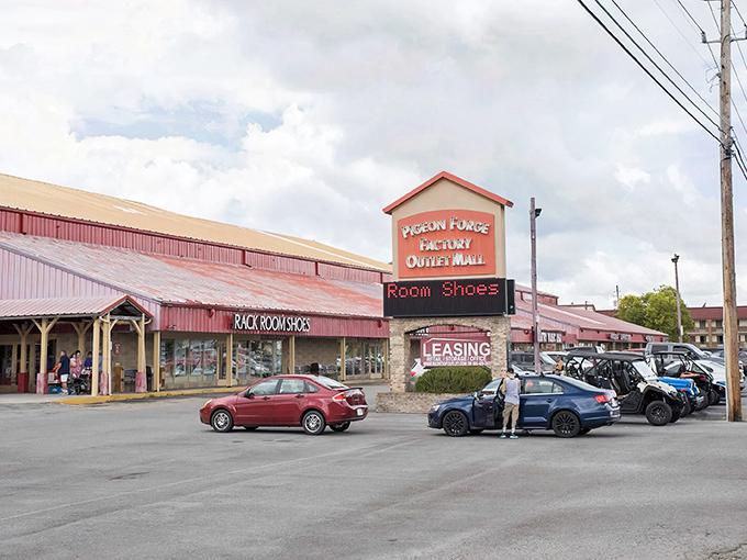 The iconic red-roofed Pigeon Forge Factory Outlet Mall stands like a beacon for bargain hunters, promising retail therapy with mountain views thrown in for free.