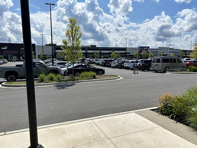 Retail therapy paradise under Tennessee blue skies. The sprawling parking lot hints at the bargain hunting adventures awaiting inside.