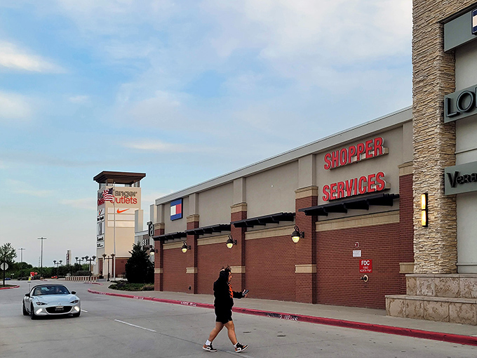 Tanger's Shopper Services center stands ready to assist bargain hunters navigating this Texas-sized retail paradise under clear blue skies.