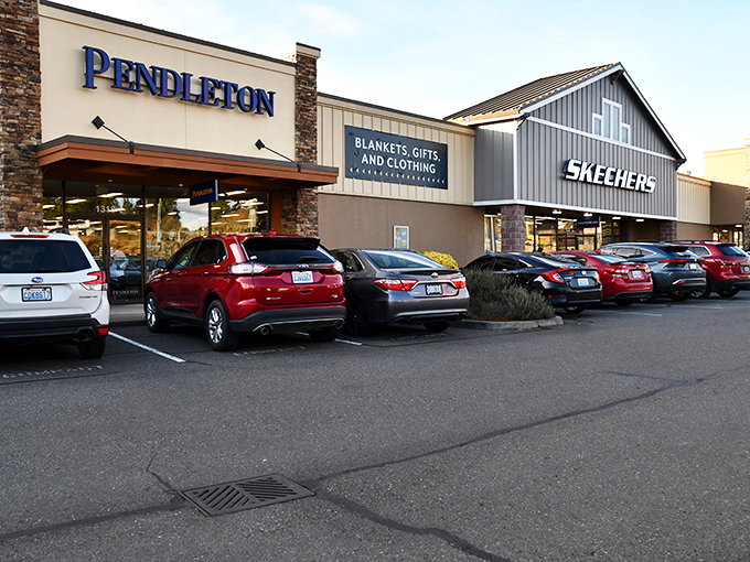 Pendleton and Skechers stand side by side like old friends, promising cozy blankets and comfortable footwear. The full parking lot tells the real story&mdash;savvy shoppers know where the deals live.