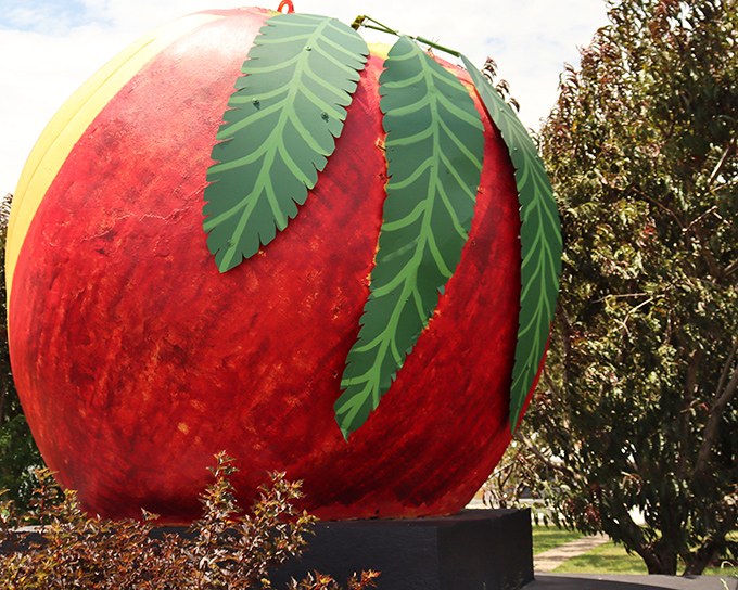The Big Peach stands proudly against the Indiana sky, a crimson colossus that makes you wonder if Jack's beanstalk might be nearby.