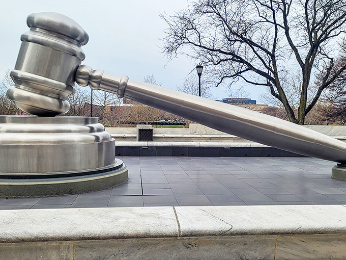Winter brings a serene dignity to the World's Largest Gavel, its polished surface contrasting dramatically with the snow-dusted plaza. Cold case, meet cold weather.