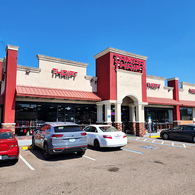 The bold red and cream exterior of Tampa Thrift stands out like a beacon for treasure hunters, promising adventures in secondhand splendor.