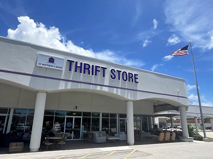 The purple-trimmed facade of St. Matthew&rsquo;s House Thrift Store stands proudly against the Florida sky, a beacon for bargain hunters with champagne taste on a root beer budget.