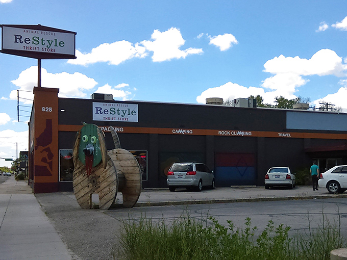 The iconic exterior of Restyle beckons with its vibrant orange trim and whimsical wooden sculptures, like a beacon for treasure hunters in Boise.