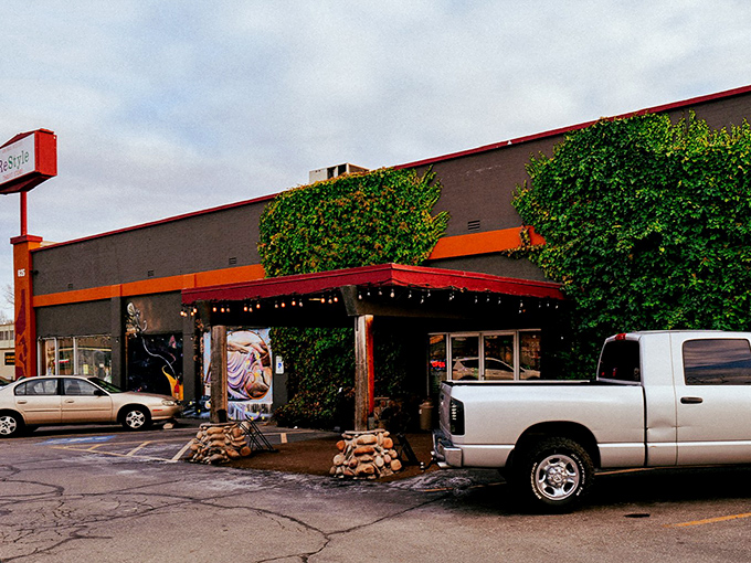 The iconic exterior of Restyle beckons with its vibrant orange trim and whimsical wooden sculptures, like a beacon for treasure hunters in Boise.