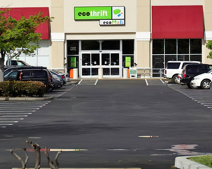 The bright green Eco Thrift sign beckons like a lighthouse for bargain hunters. Red awnings frame the entrance to this treasure-filled wonderland.