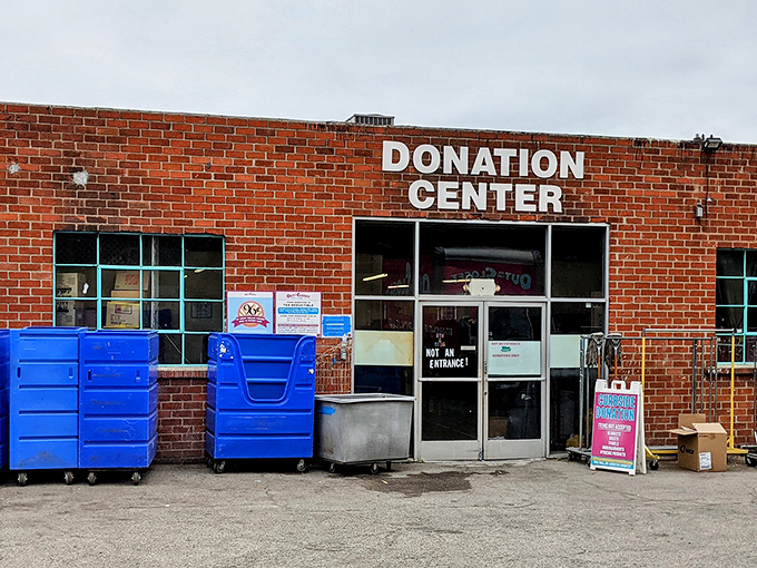 The donation center entrance stands ready with its bright blue bins, like treasure chests awaiting your cast-offs that will become someone else's gold.