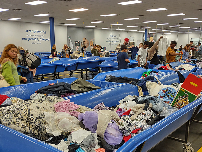 Treasure hunters in their natural habitat! The blue bins at Goodwill Taft Outlet are like archaeological digs where yesterday's castoffs become tomorrow's prized possessions.