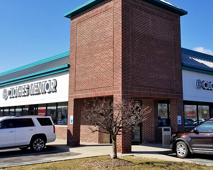 The brick-and-turquoise exterior of Clothes Mentor stands like a fashion oasis in Fishers, promising treasure hunts that won't require a second mortgage.