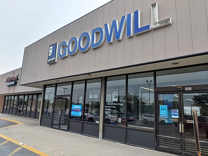 The blue GOODWILL sign beckons like a retail lighthouse, promising treasures within that won't require a second mortgage to afford.