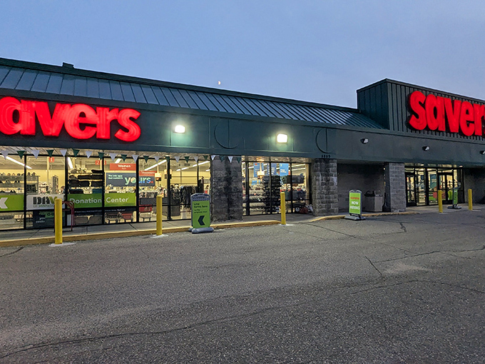 The iconic red Savers sign glows like a beacon for treasure hunters, promising adventures in secondhand splendor just beyond those automatic doors.