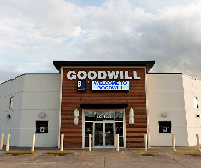 The brick-fronted Goodwill on Apples Way stands like a beacon of bargain hope, promising treasures behind those unassuming glass doors.