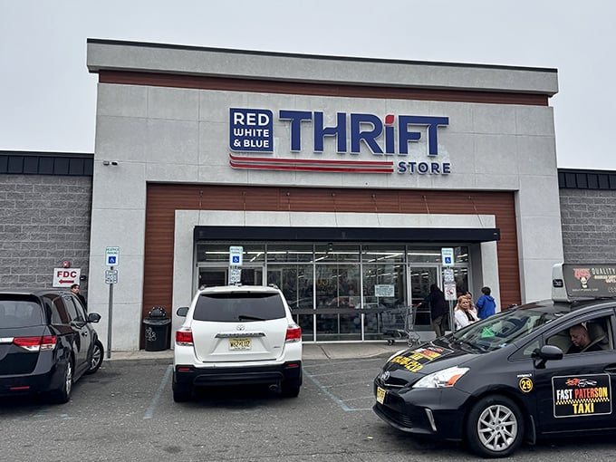 The unassuming exterior of Red White & Blue Thrift Store stands like a treasure chest waiting to be opened, promising bargain-hunting adventures under the bright New Jersey sky.