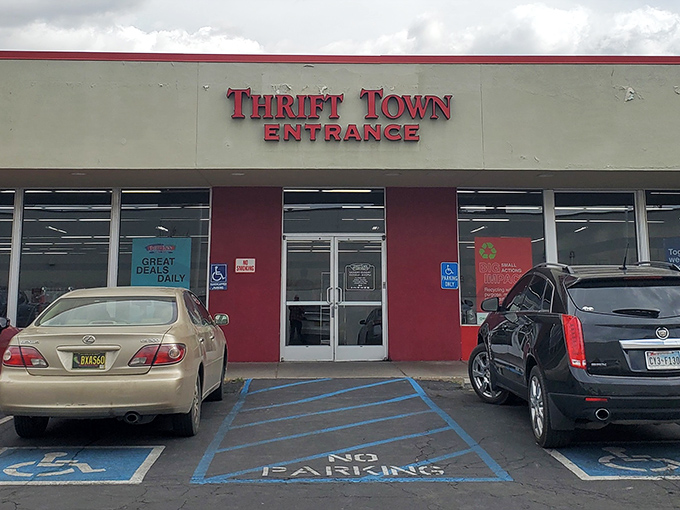 The iconic red Thrift Town sign beckons like a lighthouse for bargain hunters navigating the sea of retail sameness.