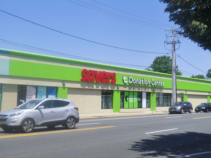 The vibrant green exterior of Savers in West Hempstead announces itself like a beacon for bargain hunters seeking retail adventure.