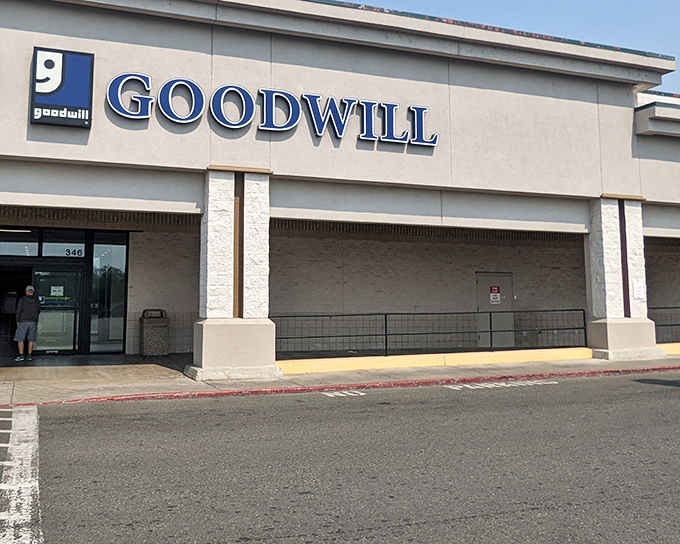 The blue Goodwill sign beckons like a lighthouse for bargain hunters. This unassuming exterior houses treasures waiting to be discovered by savvy Oregon shoppers.