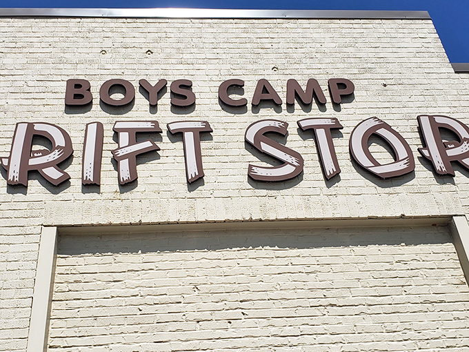 The iconic Boys Camp Thrift Store sign stands proud against a blue sky, promising treasure hunters a paradise of possibilities within those brick walls.