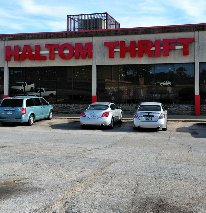 The bold red letters of Haltom Thrift stand like a beacon to bargain hunters, promising treasures within that big-box stores could never deliver.