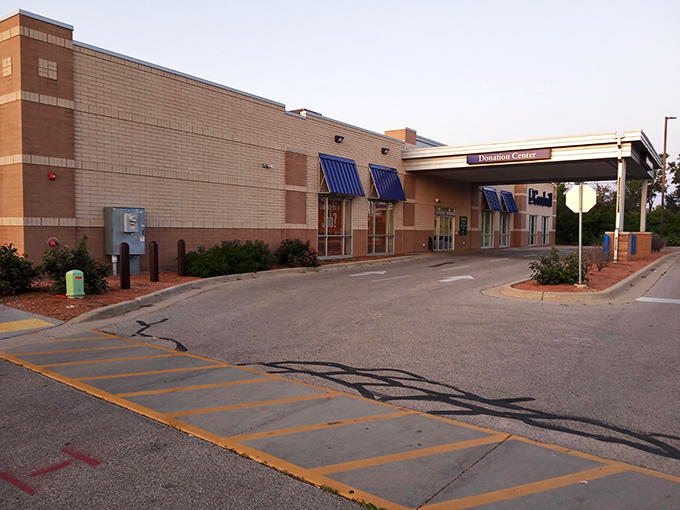 The unassuming exterior hides a universe of possibilities. Blue awnings and brick walls are merely the portal to your next great discovery.