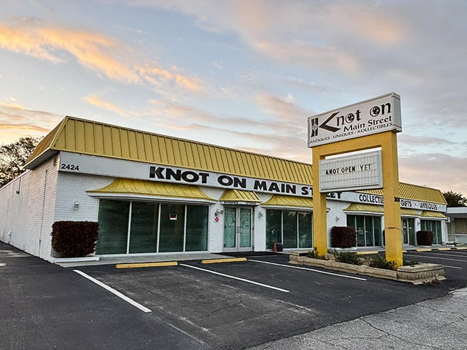 Dawn breaks over vintage paradise. Even before opening hours, Knot On Main Street's distinctive yellow signage promises adventures in nostalgia waiting just beyond those doors.
