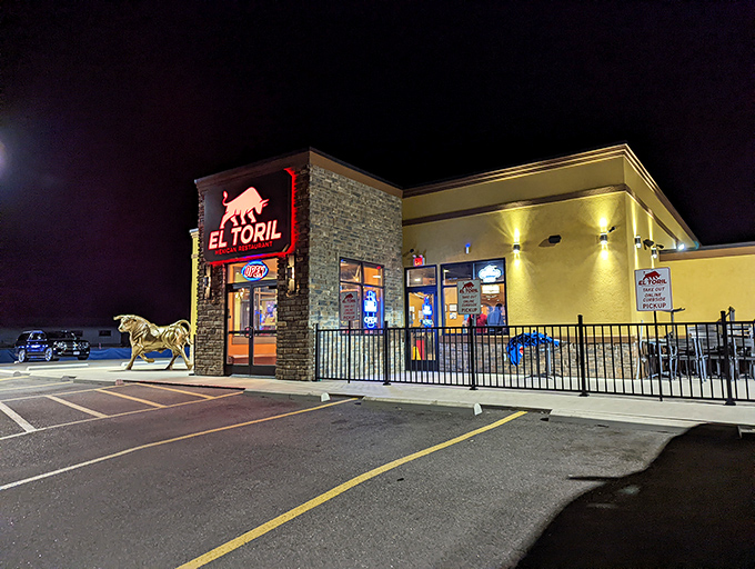At night, El Toril transforms into a beacon for hungry travelers, the golden bull sculpture standing guard like a sentinel of satisfaction.