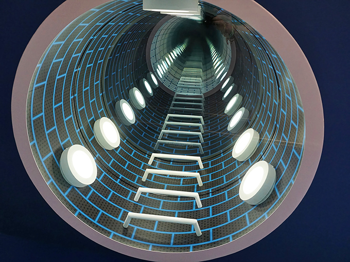 Down the rabbit hole you go! This mind-bending tunnel installation creates the perfect illusion of infinite depth, making you question just how far reality extends.