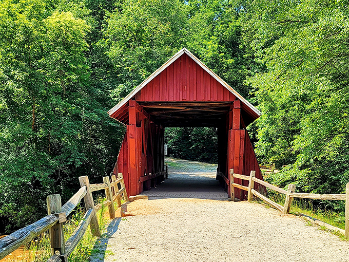 The iconic red siding of Campbell's Covered Bridge creates a striking contrast against South Carolina's lush greenery, like a cardinal perched among summer leaves.
