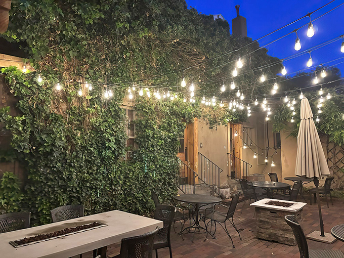 String lights dance overhead like stars, creating a secret garden atmosphere. The perfect backdrop for savoring prime rib while the New Mexico evening unfolds.