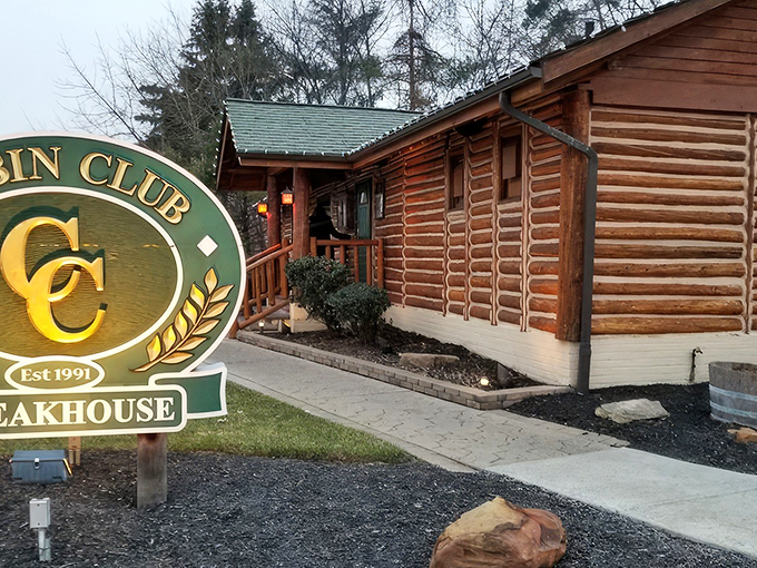 A closer look at the Cabin Club's authentic log construction reveals its charming entrance, where the green and gold sign welcomes hungry travelers to steakhouse nirvana.