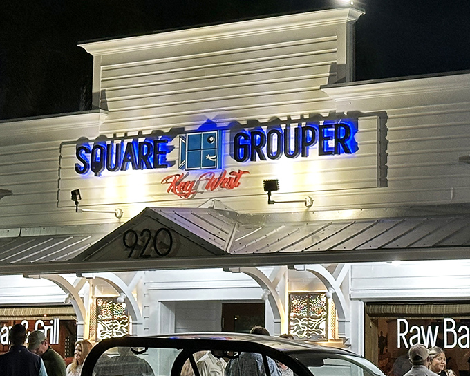 The blue neon sign of Square Grouper glows like a beacon for hungry travelers. Key West's culinary secret hiding in plain sight.
