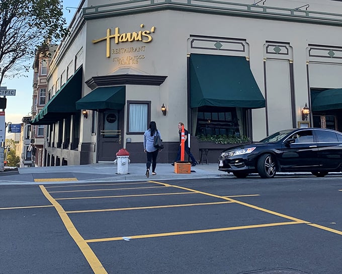The elegant cream exterior with signature green awnings stands as a beacon of culinary tradition on Van Ness Avenue, promising carnivorous delights within.