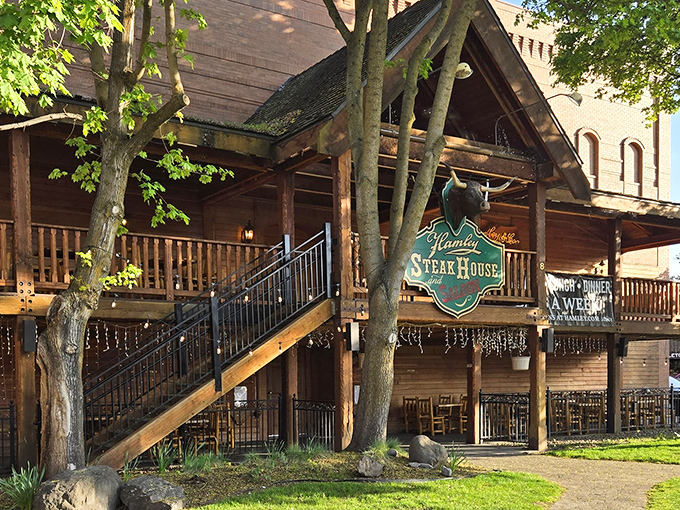 Nestled among leafy trees, Hamley's wooden exterior feels like stepping into a frontier town where steaks sizzle and stories flow freely.