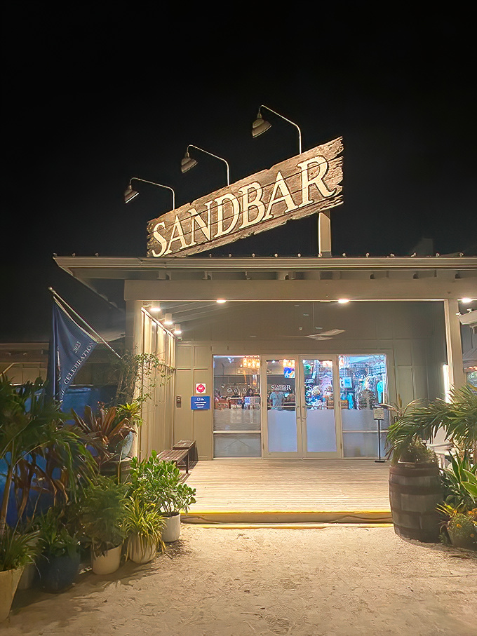 The Sandbar's illuminated sign glows like a beacon for hungry seafood lovers. Florida nights were made for places like this.