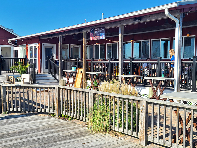The rustic red exterior of The Shanty beckons like a maritime mirage, promising seafood treasures behind its weathered wooden deck and casual coastal charm.