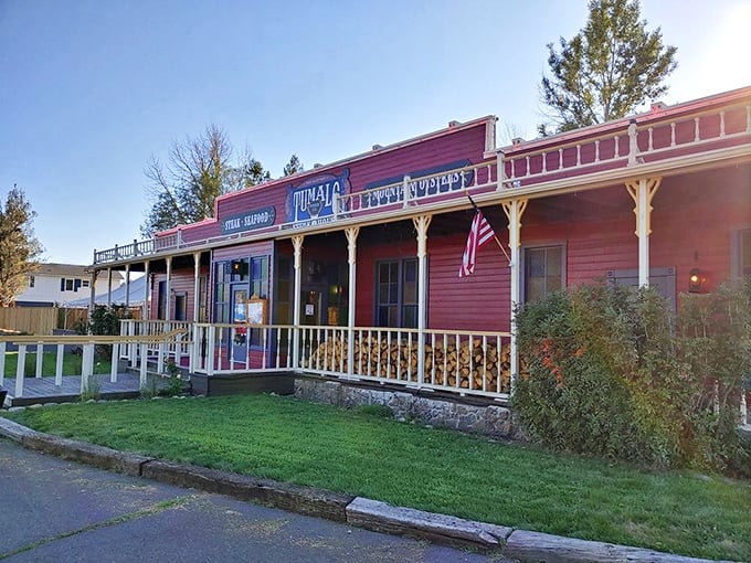 The Wild West meets culinary excellence at Tumalo Feed Company's iconic red exterior. Those hanging flower baskets aren't just for show&mdash;they're welcoming you to steak paradise.