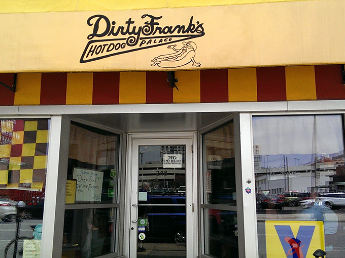 The vibrant yellow and red exterior of Dirty Frank's stands out against Columbus's skyline like a beacon for hungry hot dog pilgrims.