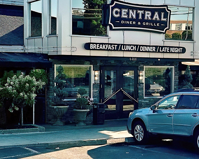 The blue-and-white sign of Central Diner & Grille beckons like an old friend, promising comfort food that'll make your cardiologist wince and your soul sing.