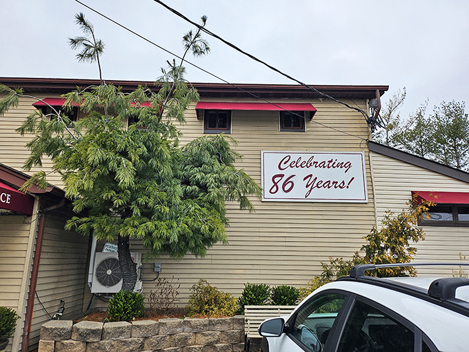 A humble beige exterior with red awnings and a "Celebrating 86 Years!" sign &ndash; proof that culinary greatness doesn't need flashy architecture.