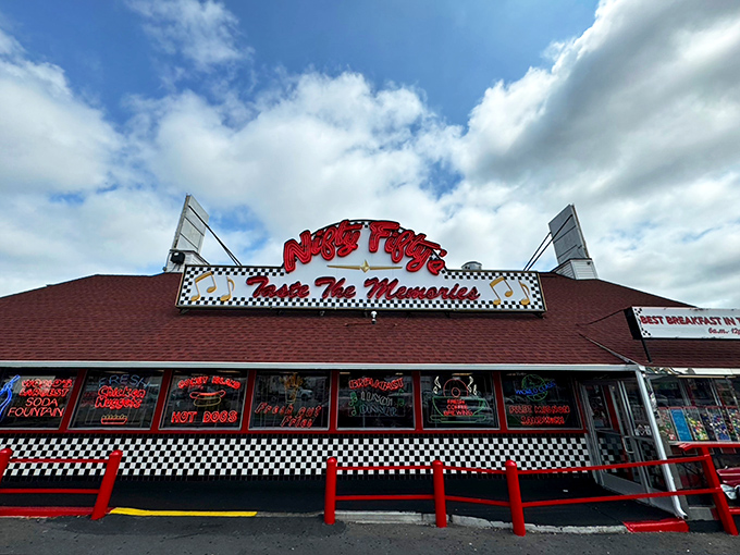 The neon-bright exterior of Nifty Fifty's stands like a time portal to the 1950s, promising nostalgic flavors under that distinctive red roof.