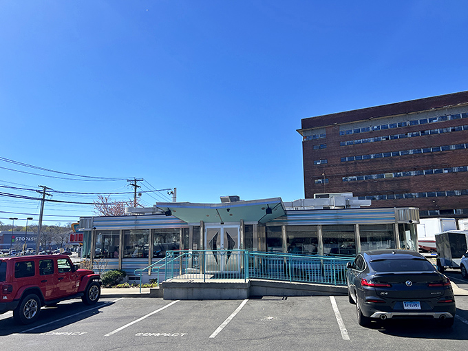 The classic American diner dream stands proudly against Connecticut's blue sky, promising comfort food treasures within its gleaming, retro exterior.