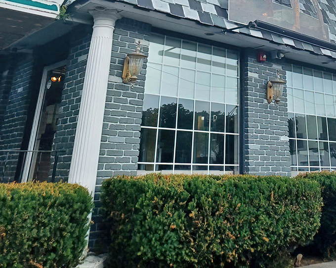 The classic brick exterior with its pristine windows and manicured shrubs promises the kind of hospitality that's become increasingly rare in our fast-casual world.