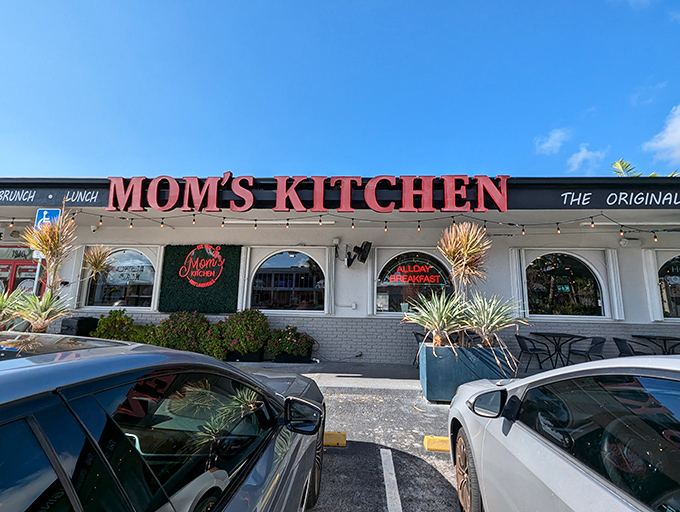 Mom's Kitchen's iconic red signage glows like a beacon for breakfast lovers, promising comfort in neon form.