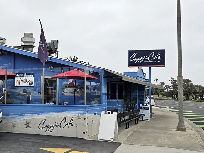 Cappy's distinctive blue exterior stands as a beacon of breakfast hope along Newport Beach's coastline, drawing hungry pilgrims daily.