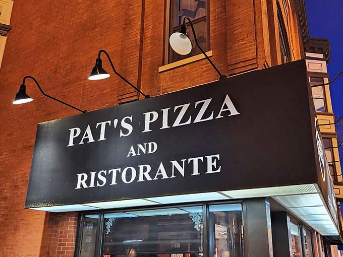 The simple black-and-white sign of Pat's Pizza & Ristorante stands as a welcoming landmark in Chicago's Lincoln Park neighborhood.