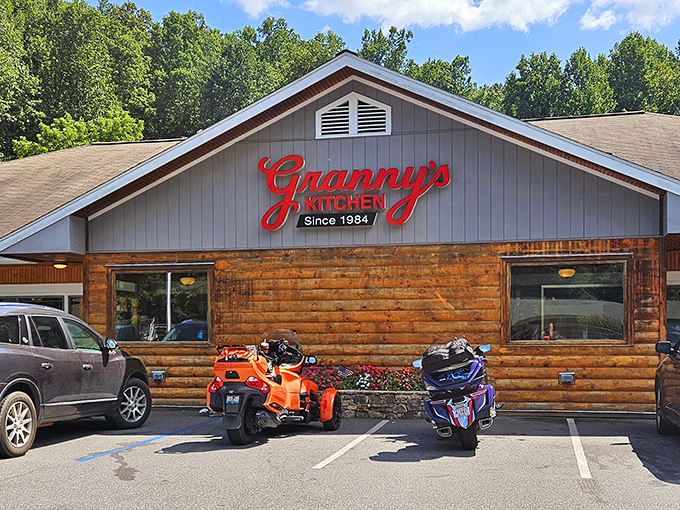 The rustic log cabin exterior of Granny's Kitchen promises mountain comfort before you even step inside. That red sign? It's basically a beacon of deliciousness.